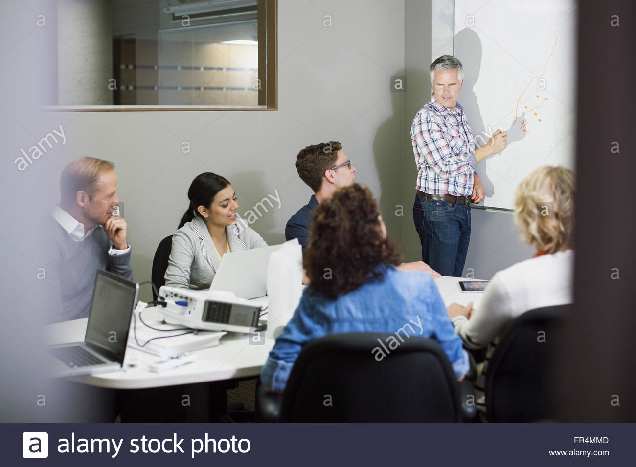 middle-aged office worker making presentation to coworkers Stock Photo ...