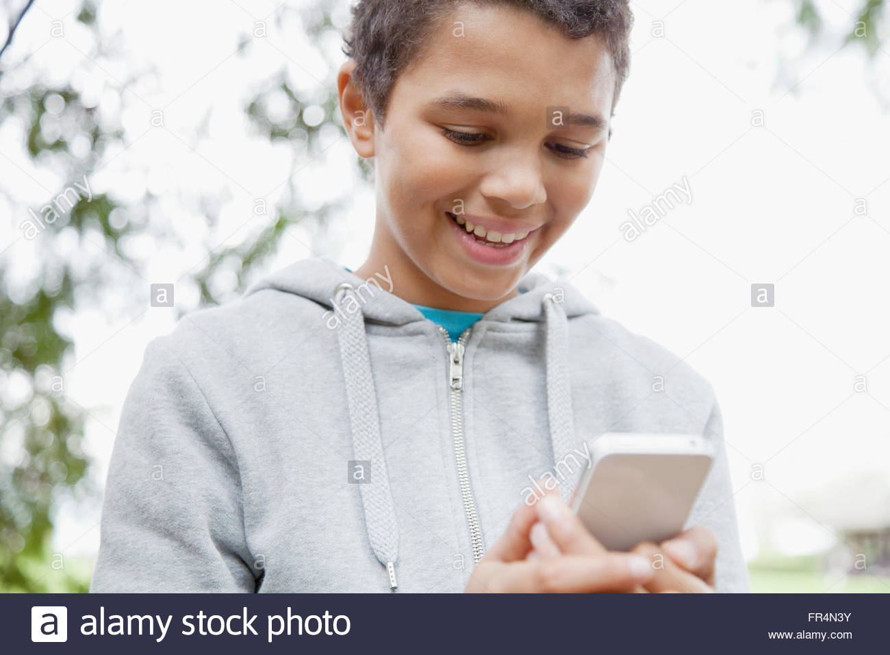 Portrait of African American youth using smart phone Stock Photo - Alamy