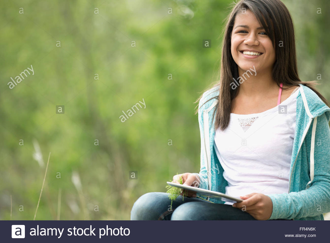 Portrait of pretty, middle school student sitting outdoors Stock Photo ...