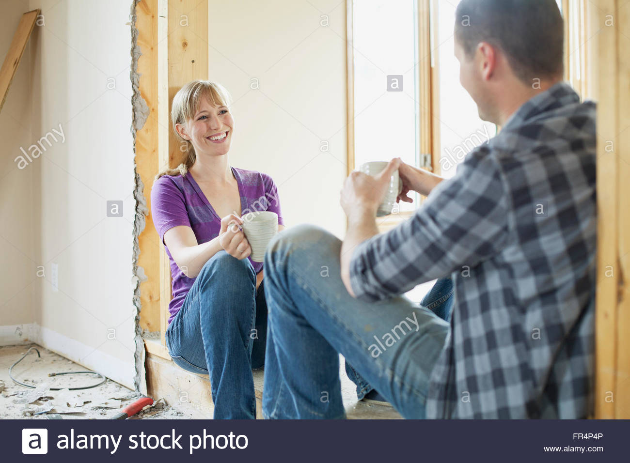 mid adult couple taking a break from renovations Stock Photo - Alamy