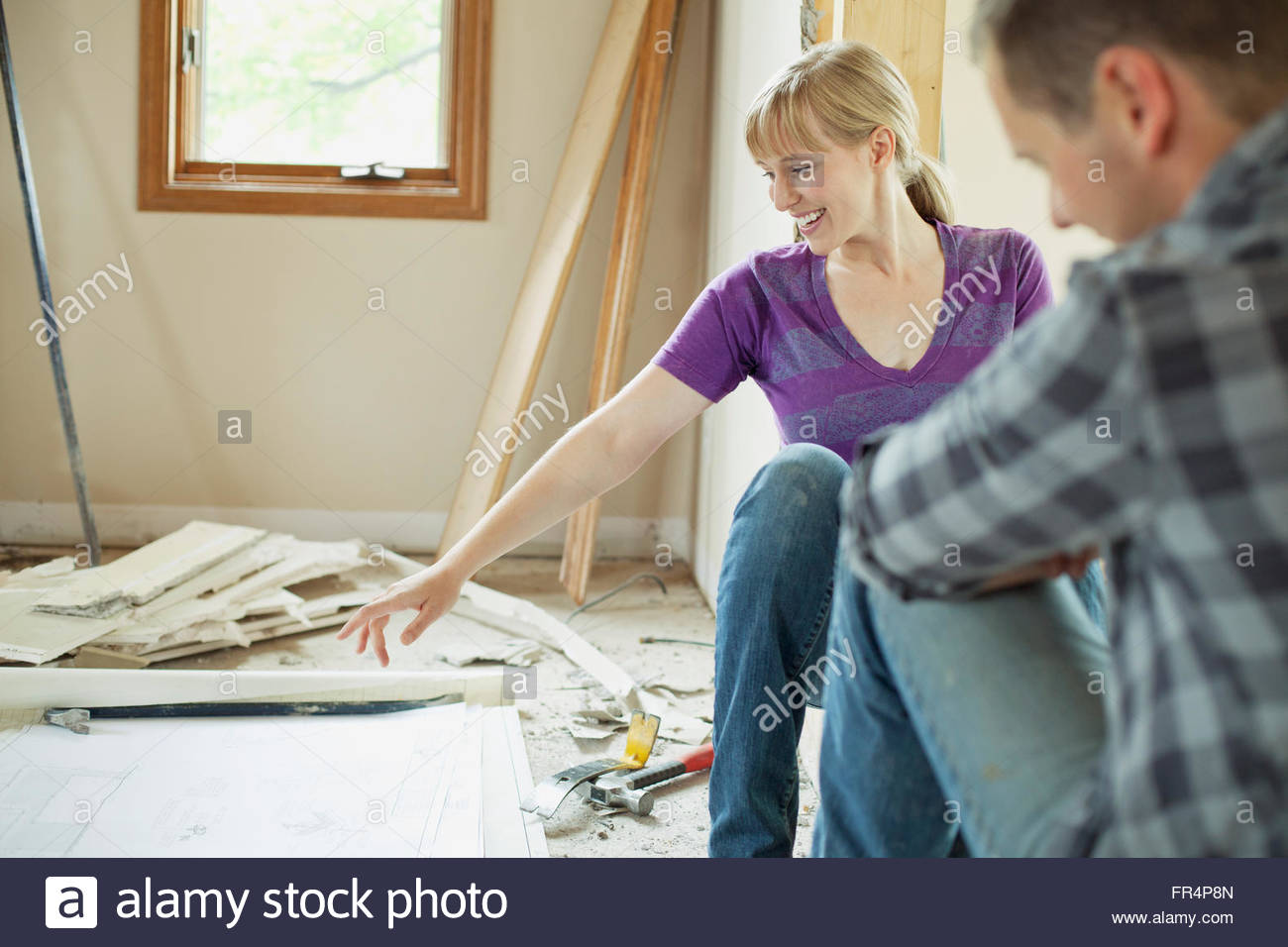 mid adult couple taking break from renovations Stock Photo - Alamy