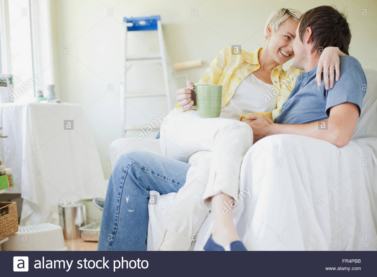 mid adult couple taking break from painting Stock Photo - Alamy