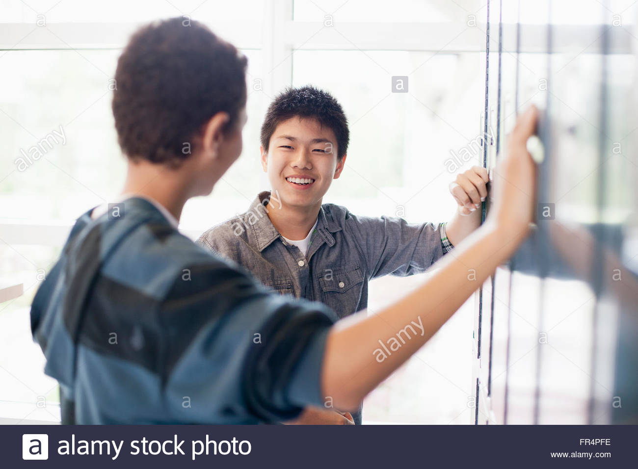 male students talking at school lockers Stock Photo - Alamy