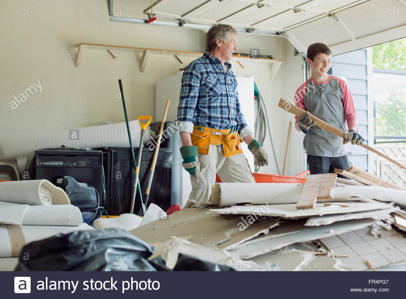father and son in the garage with discarded renovation materials Stock ...