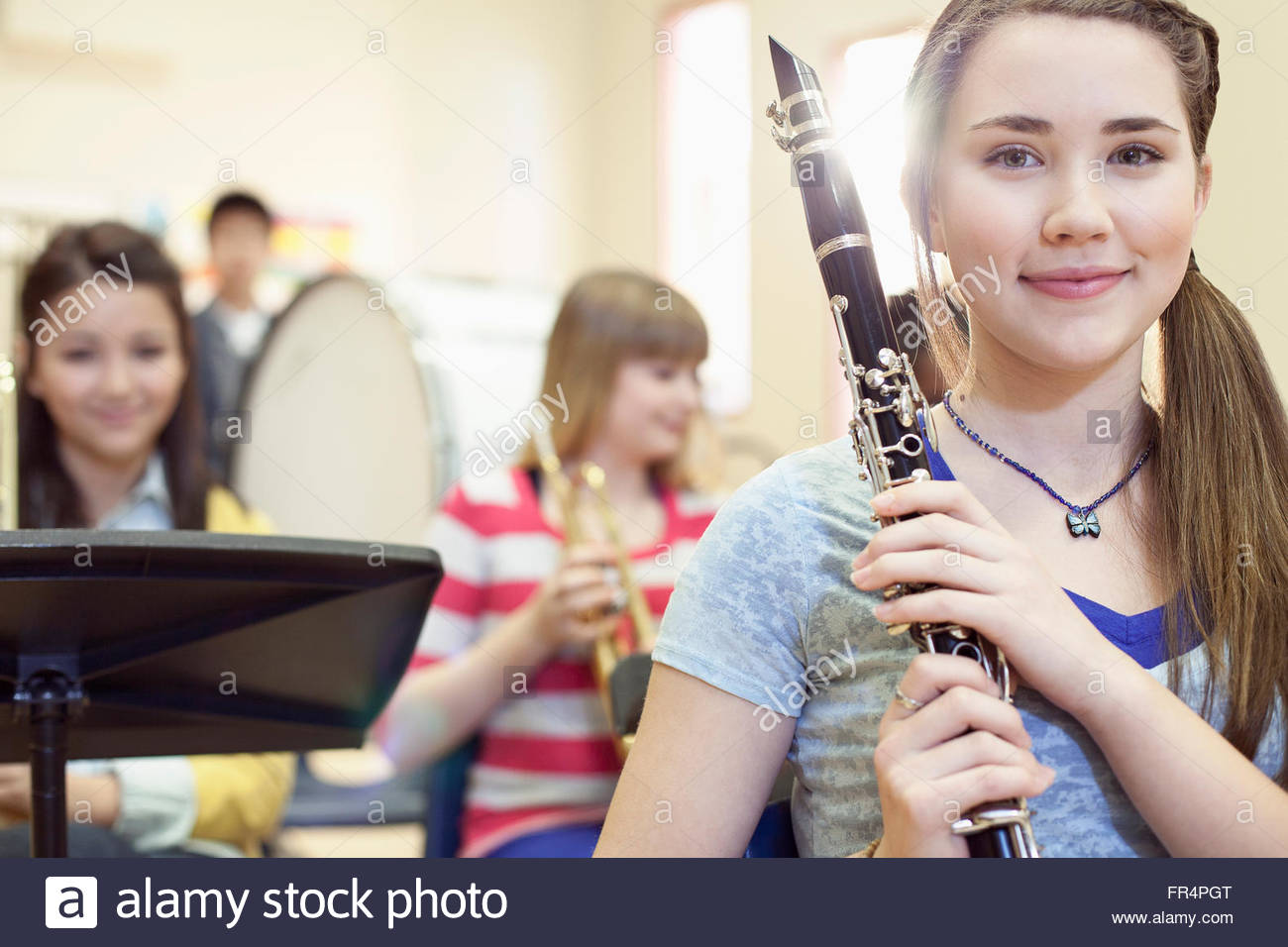 portrait of pretty school band member holding clarinet Stock Photo - Alamy