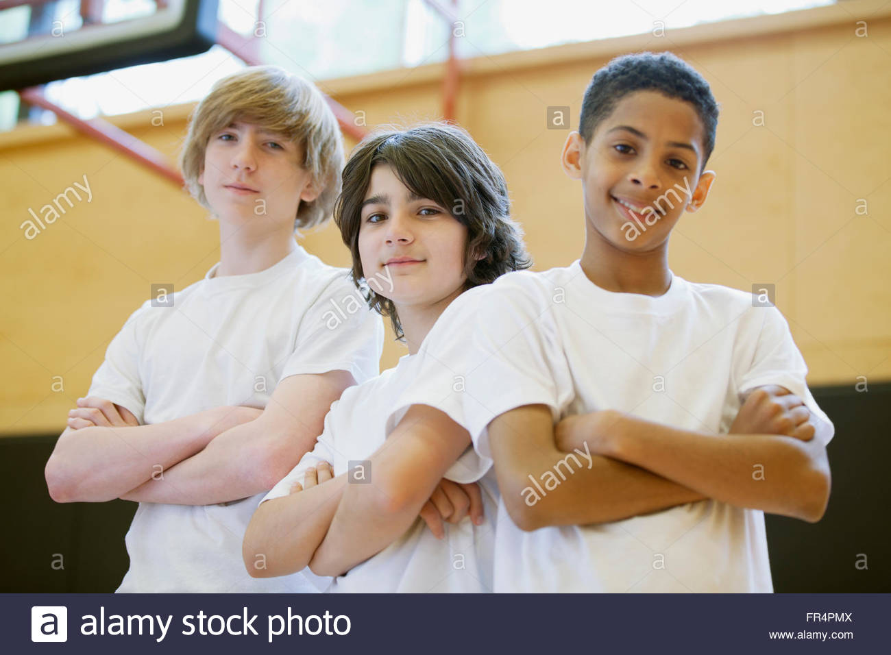 three male teenage students posing in gymnasium Stock Photo - Alamy