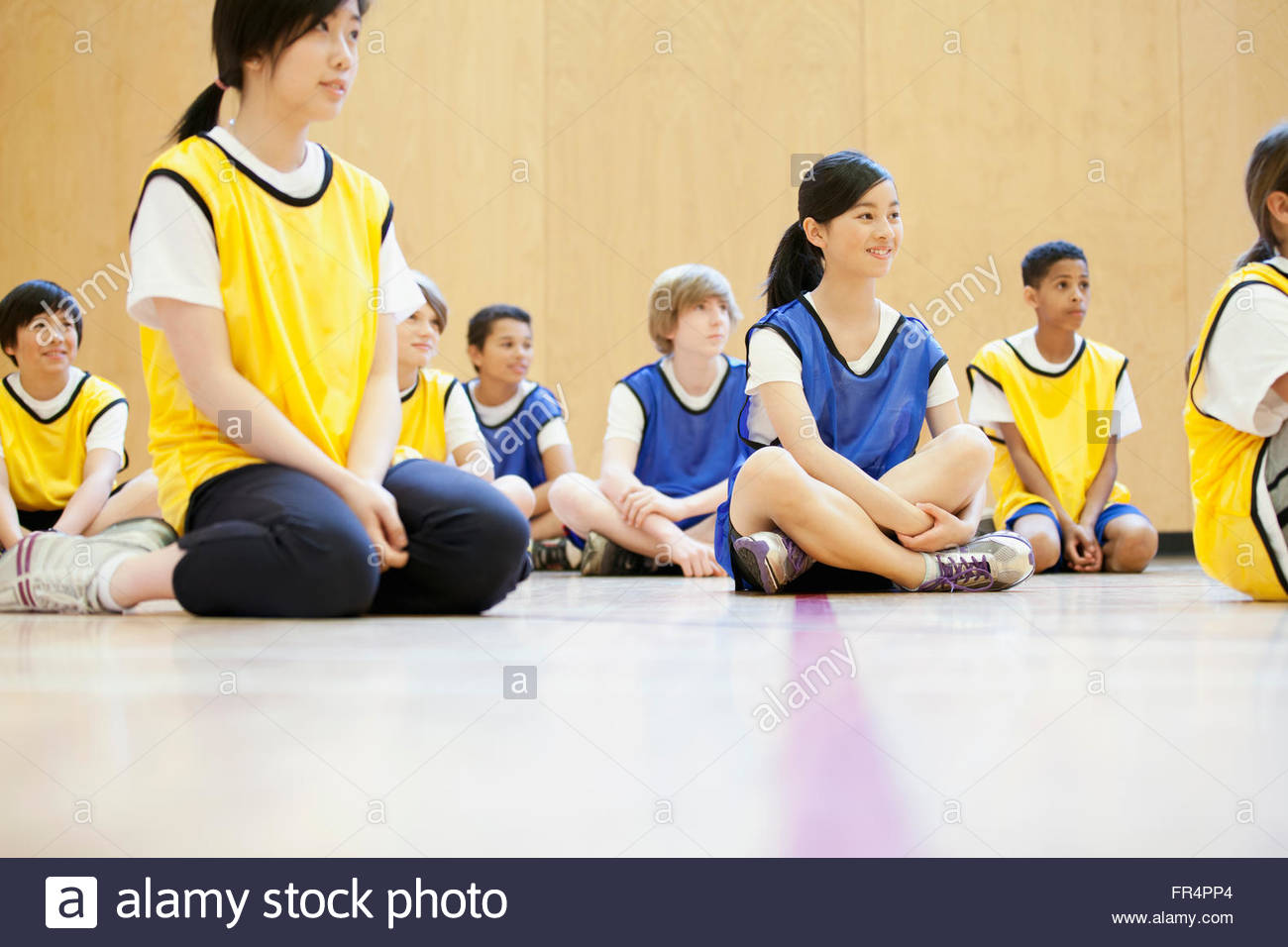group of middle school students sitting in the gymnasium Stock Photo ...