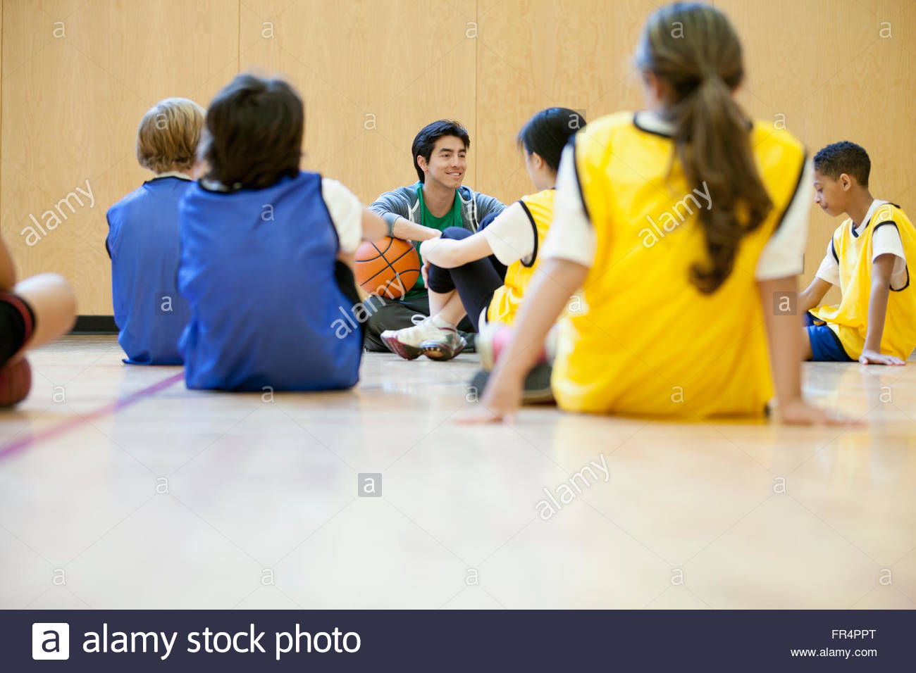 basketball teams listening to teacher Stock Photo - Alamy