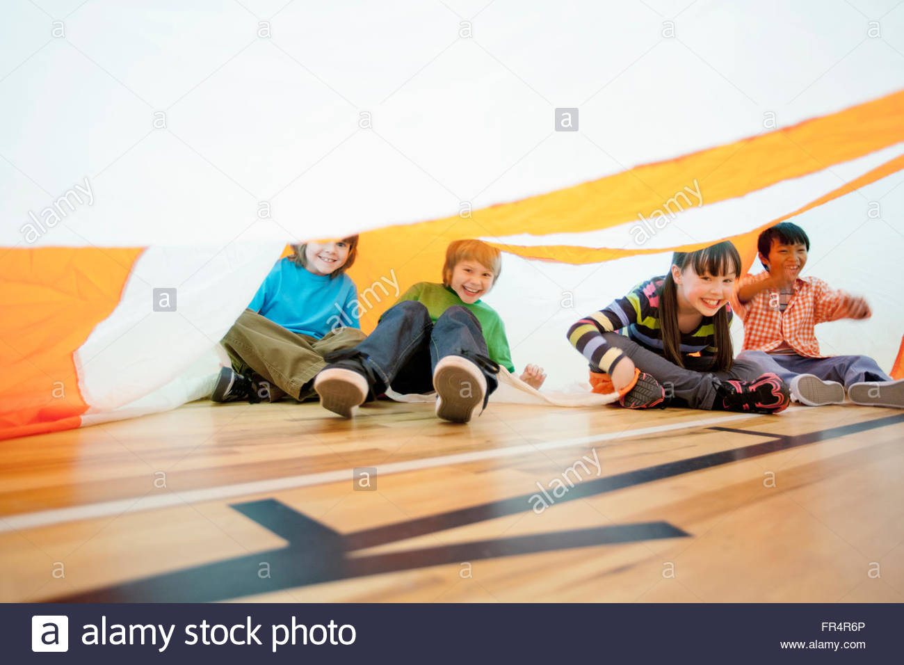 elementary students playing in gymnasium Stock Photo - Alamy