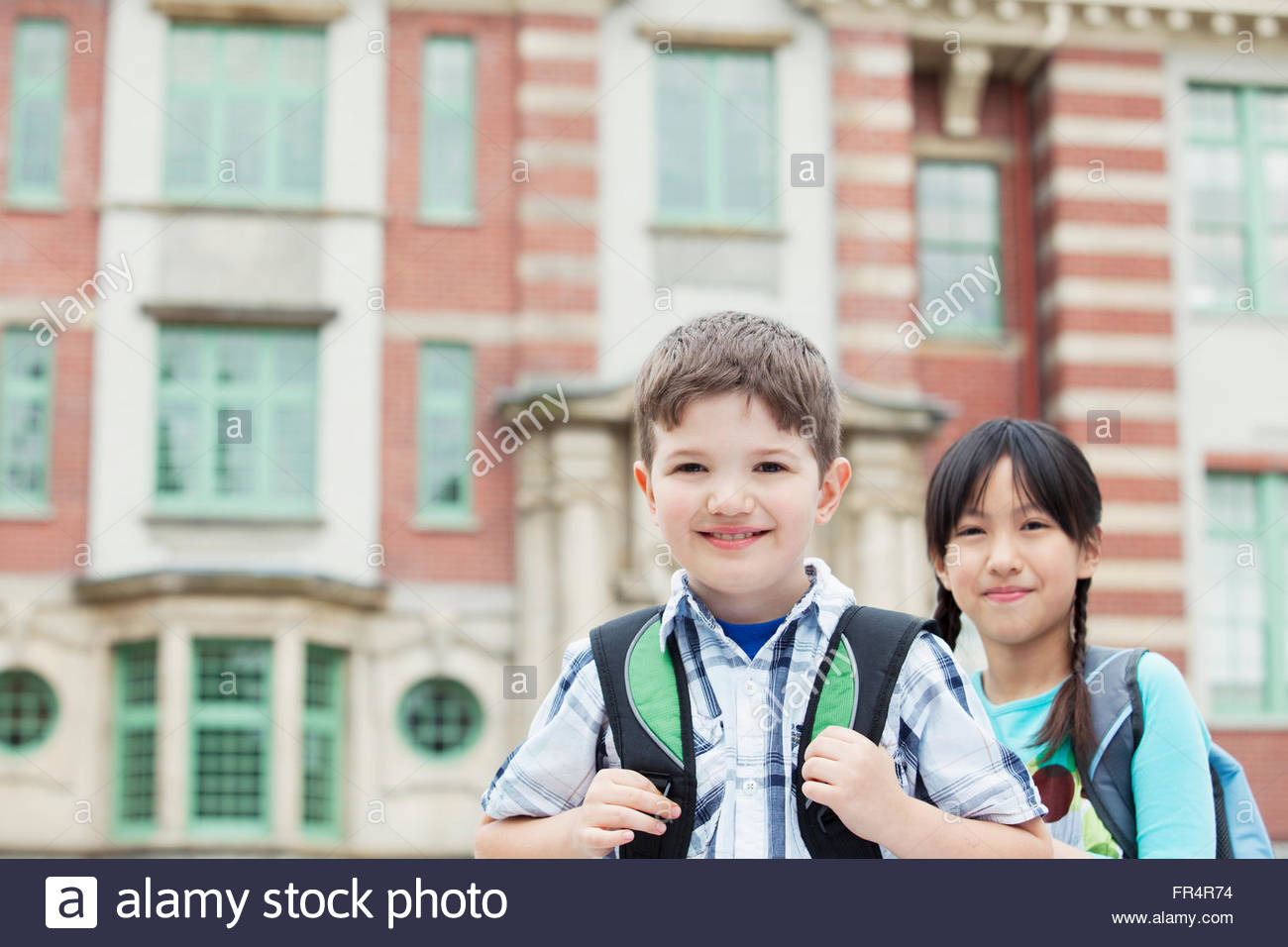 elementary students in front of school building Stock Photo - Alamy