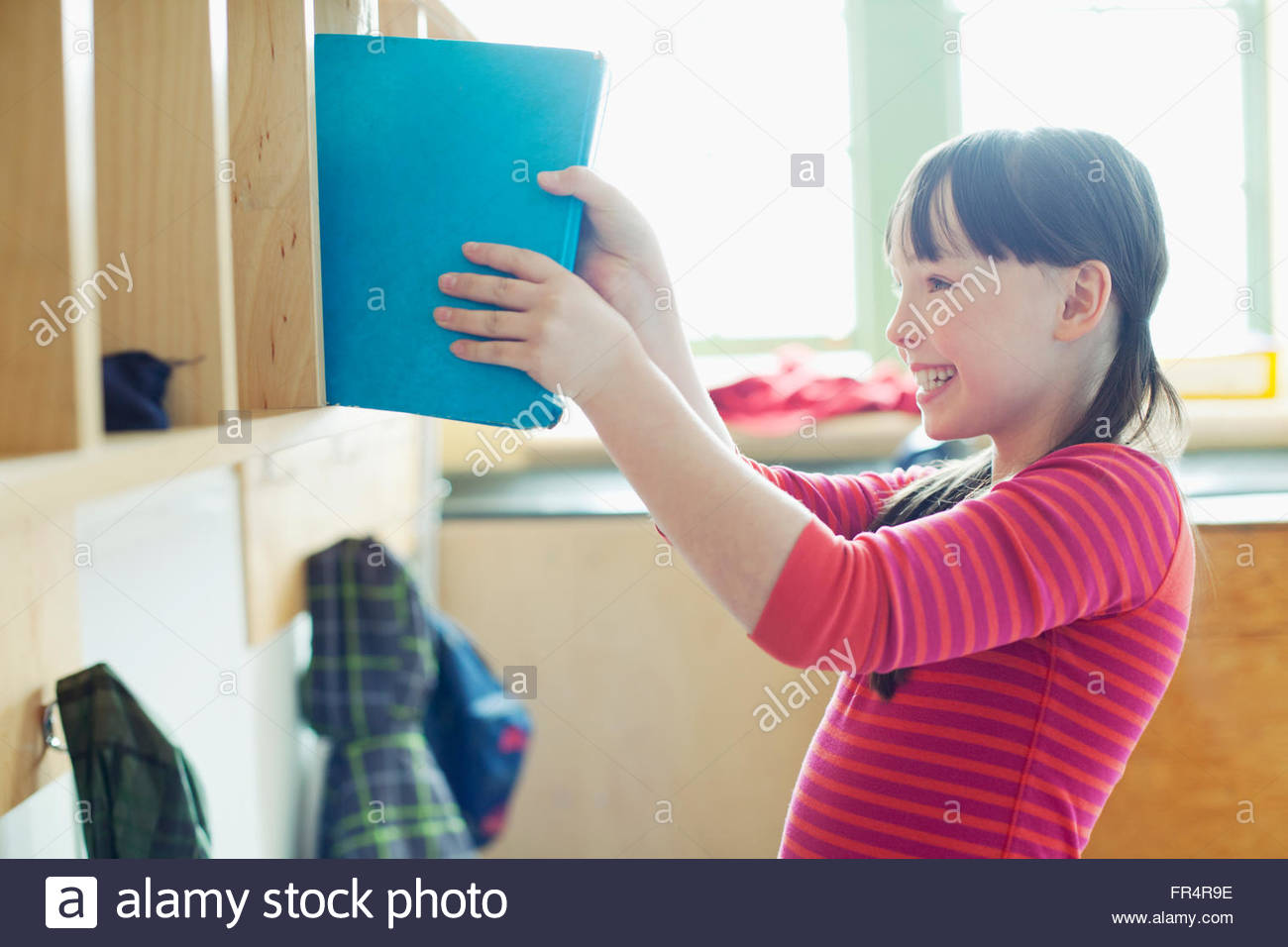 elementary student storing away book Stock Photo - Alamy