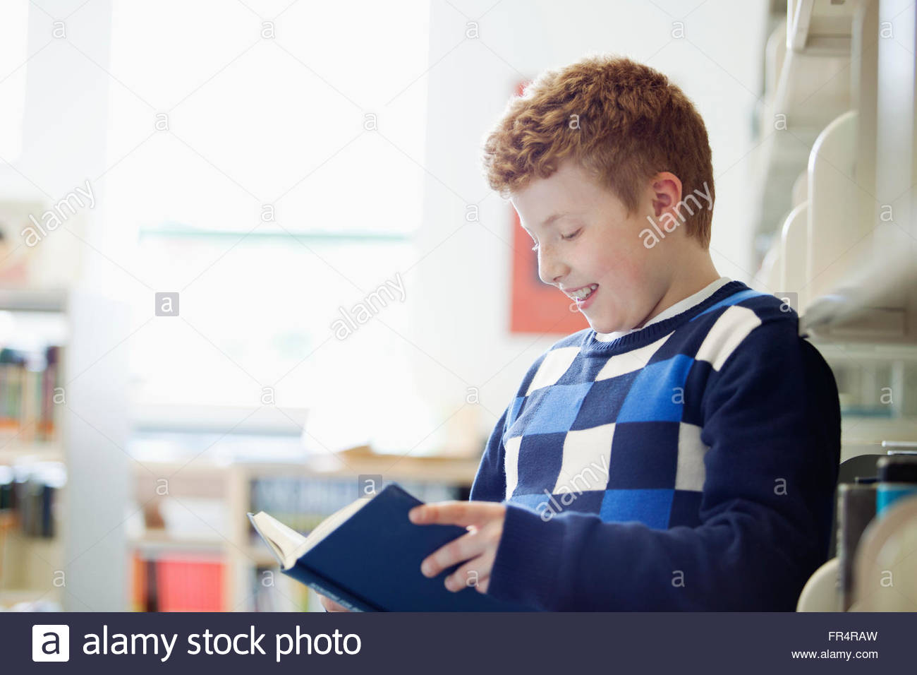 elementary student reading book Stock Photo - Alamy