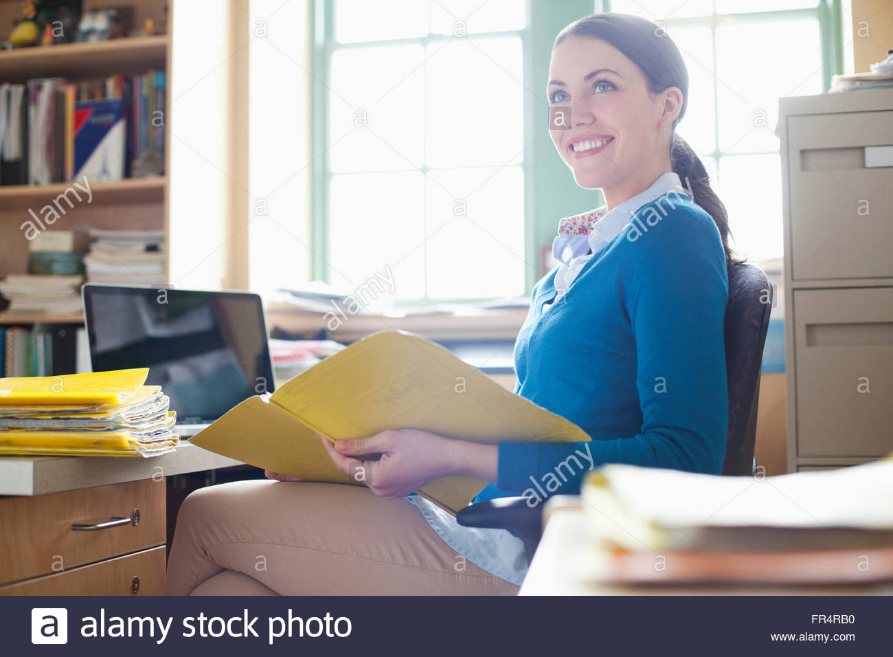 Teacher marking books hi-res stock photography and images - Alamy