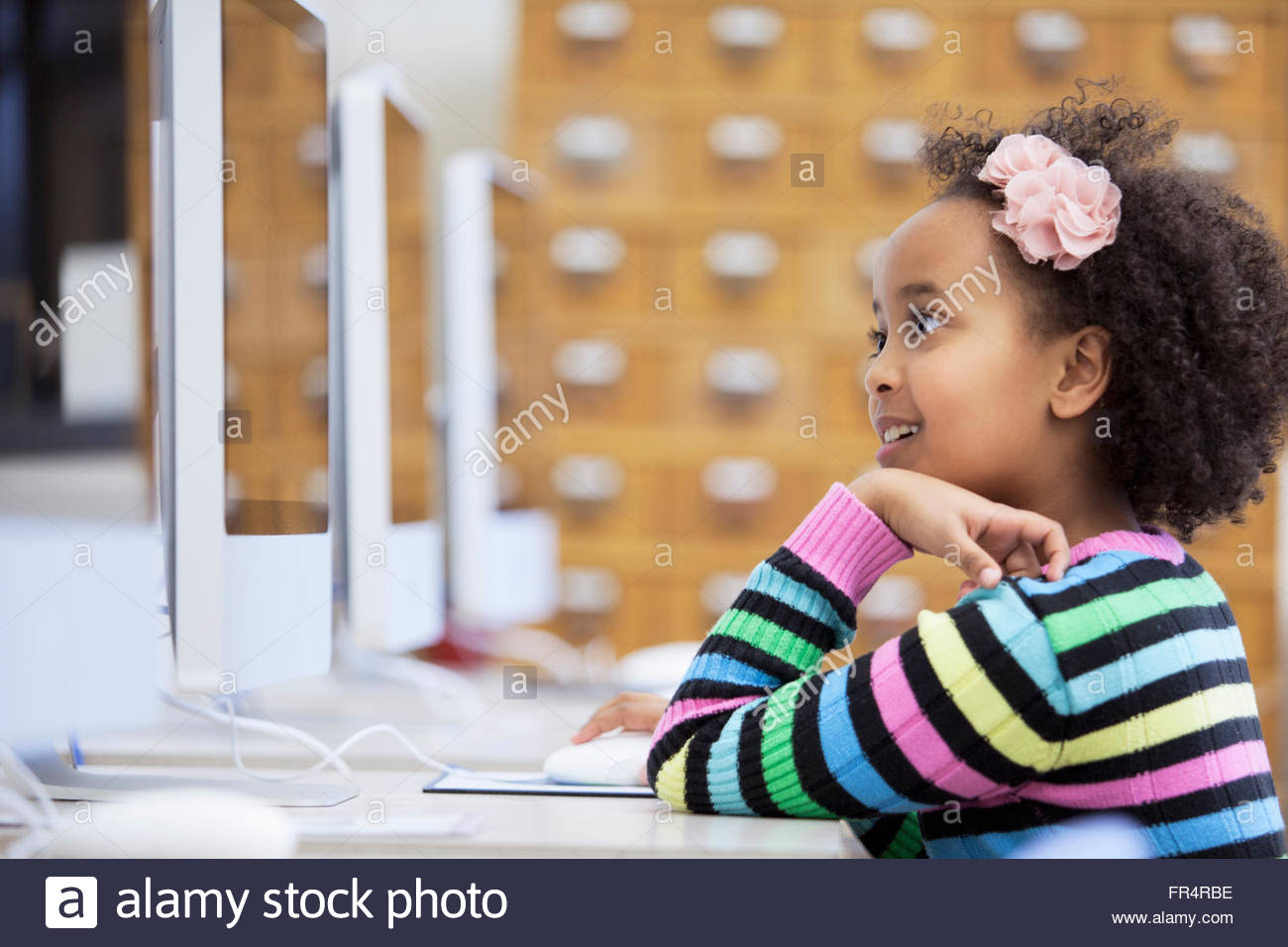 cute, elementary student using computer Stock Photo - Alamy