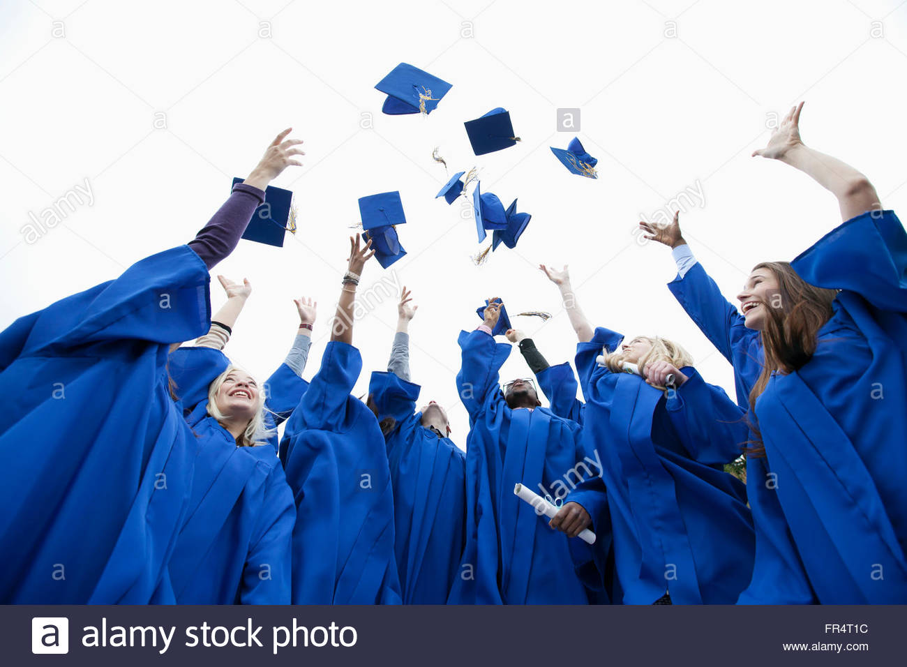Graduation caps in the air hi-res stock photography and images - Alamy