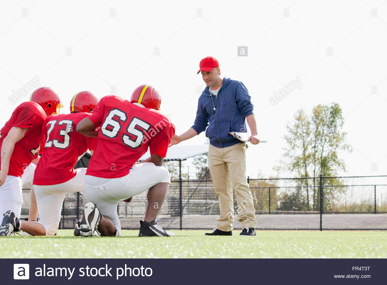 Football players and coach hi-res stock photography and images - Alamy