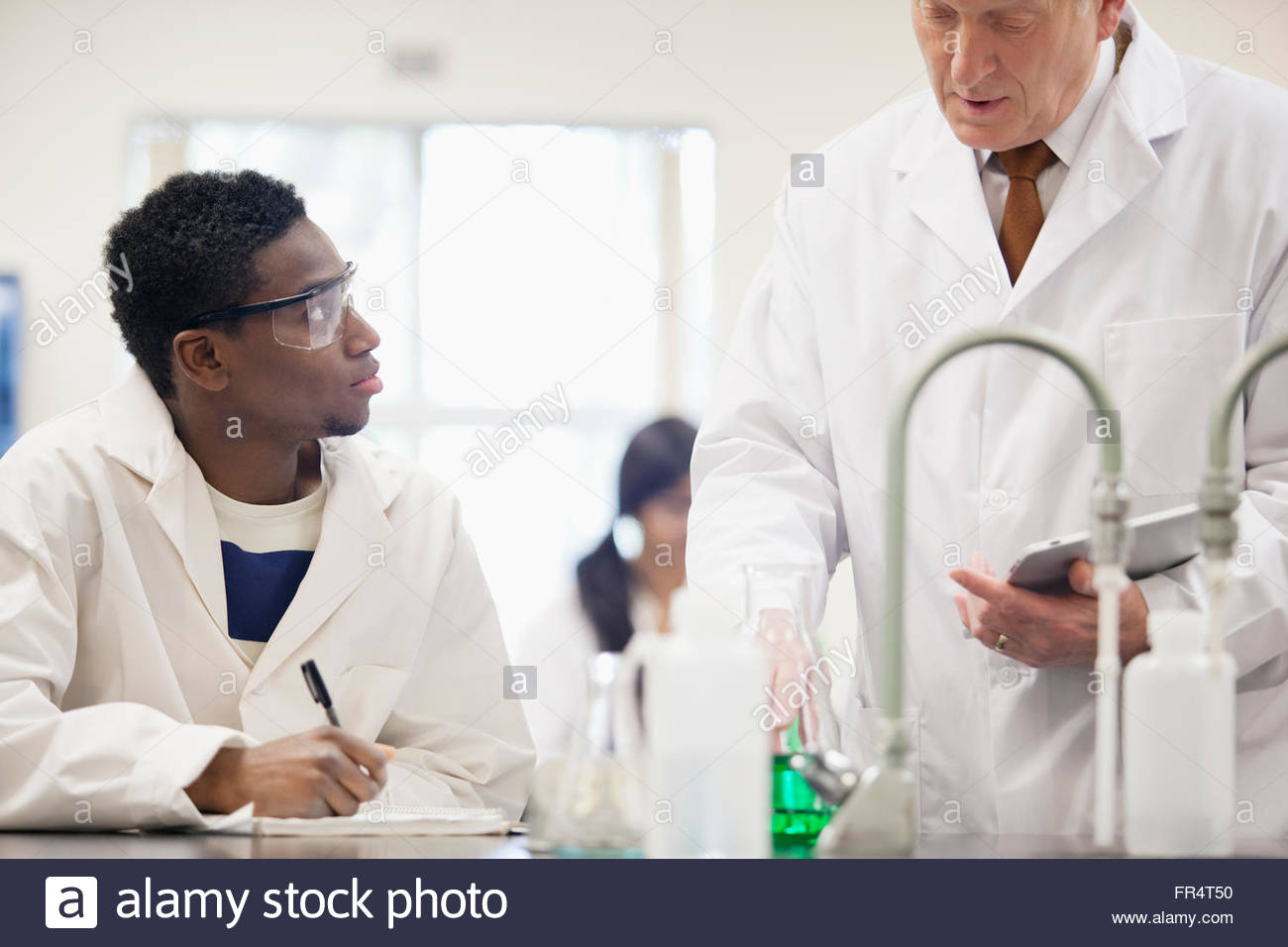 professor helping student in science lab Stock Photo - Alamy