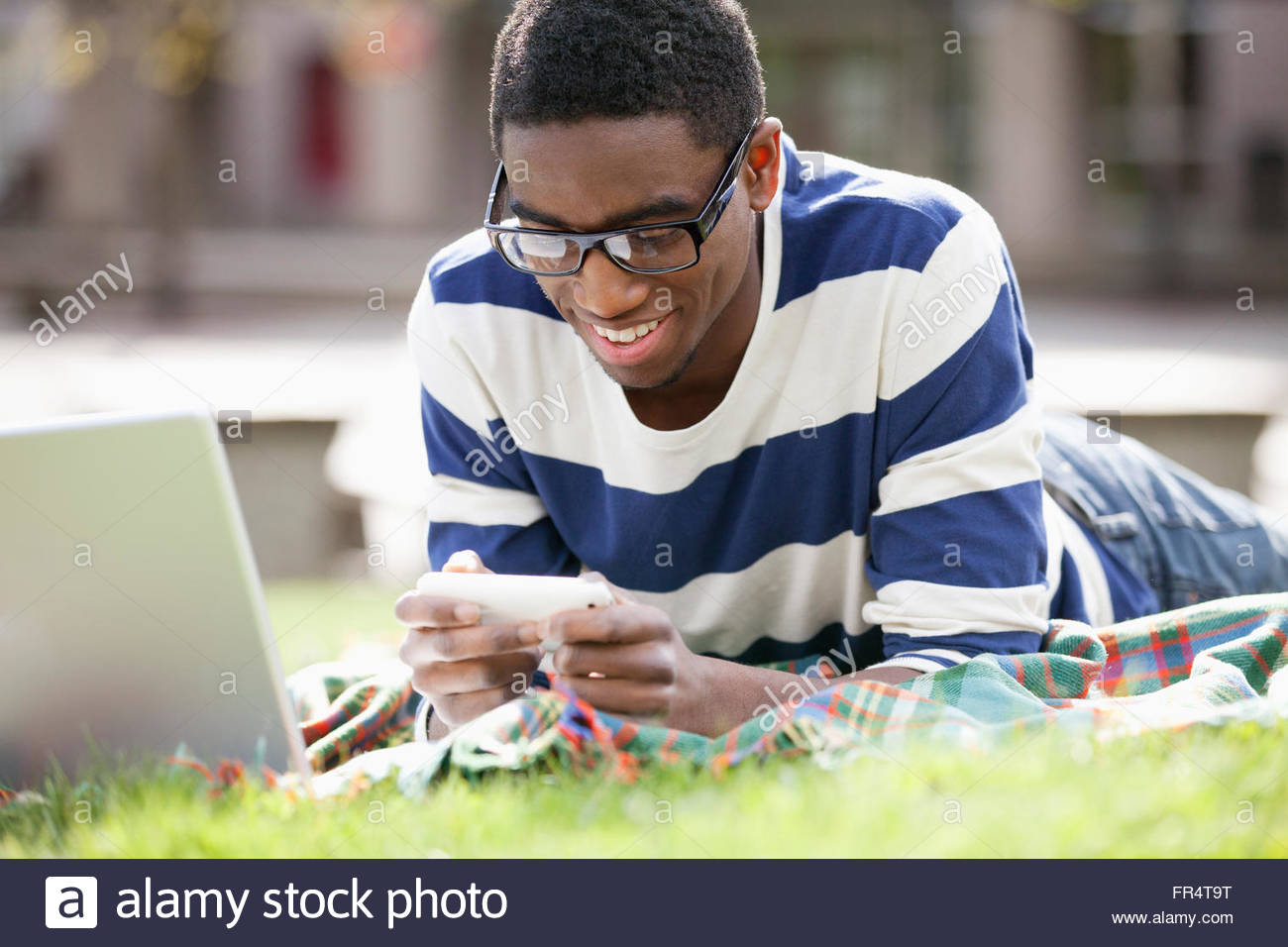 college student using computer technology coutdoors Stock Photo - Alamy