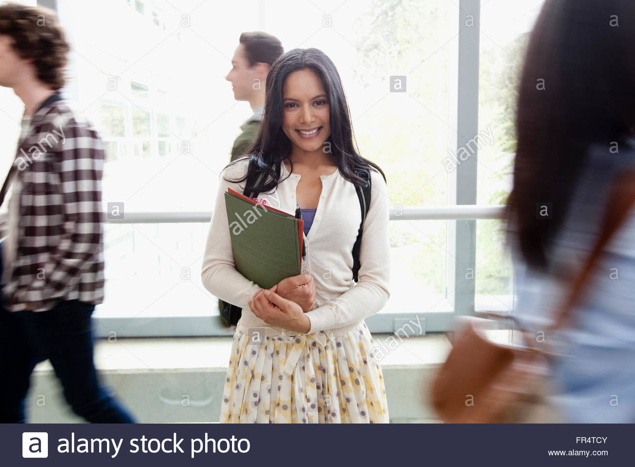 students in hallway as peers pass by Stock Photo - Alamy