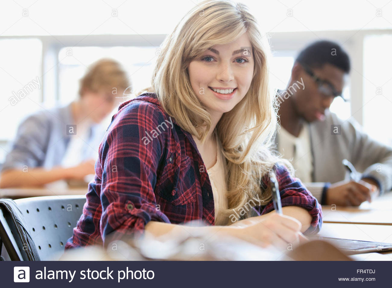 college students writing in class Stock Photo - Alamy