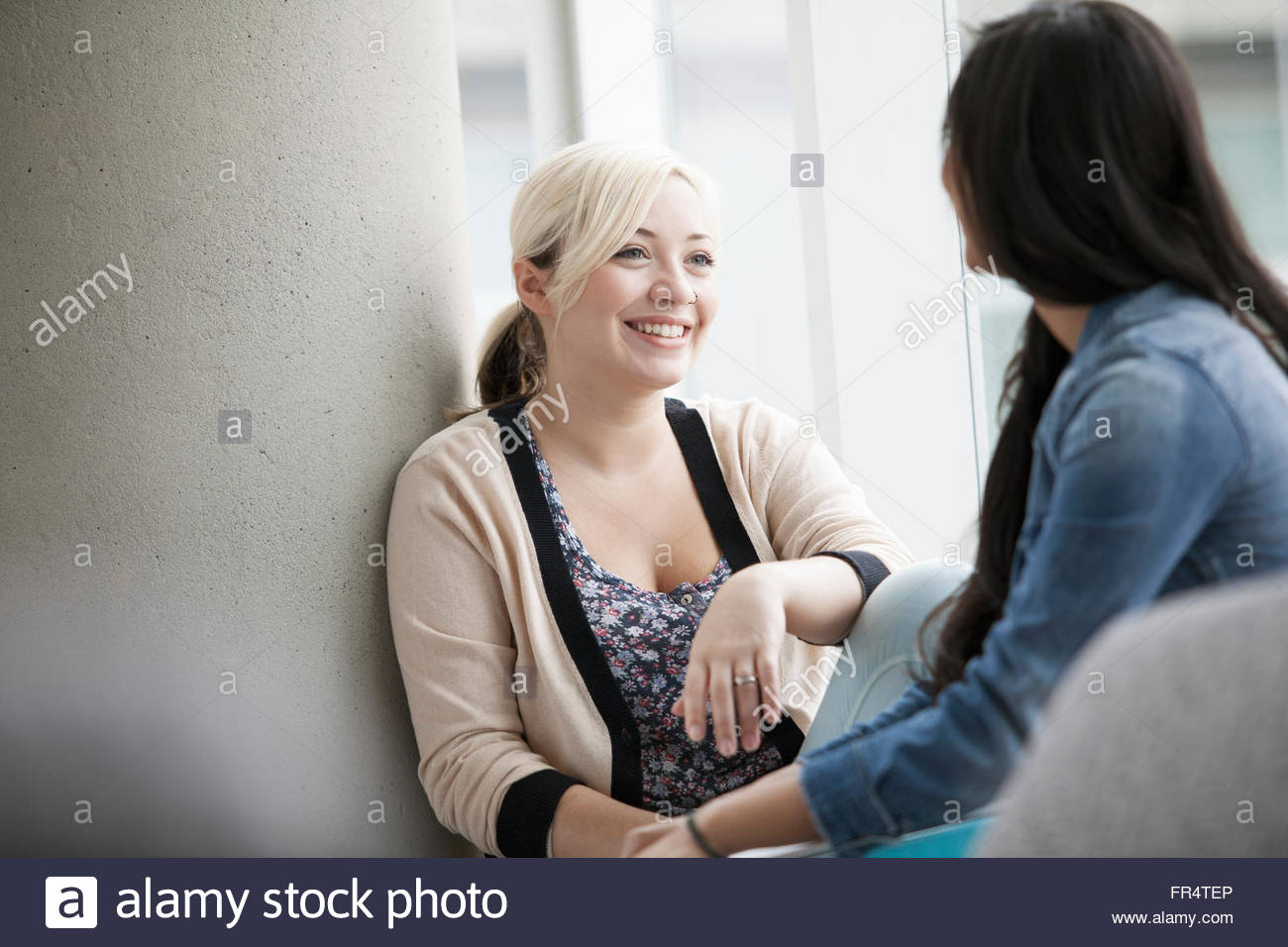 college girls socializing in hall Stock Photo - Alamy