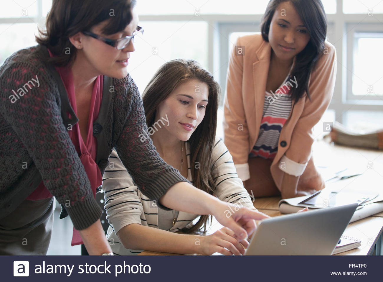 college teacher helping female students Stock Photo - Alamy