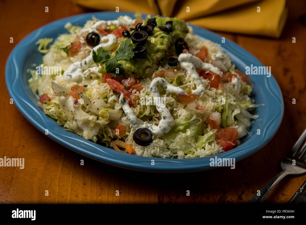 Tostada on blue plate Stock Photo - Alamy