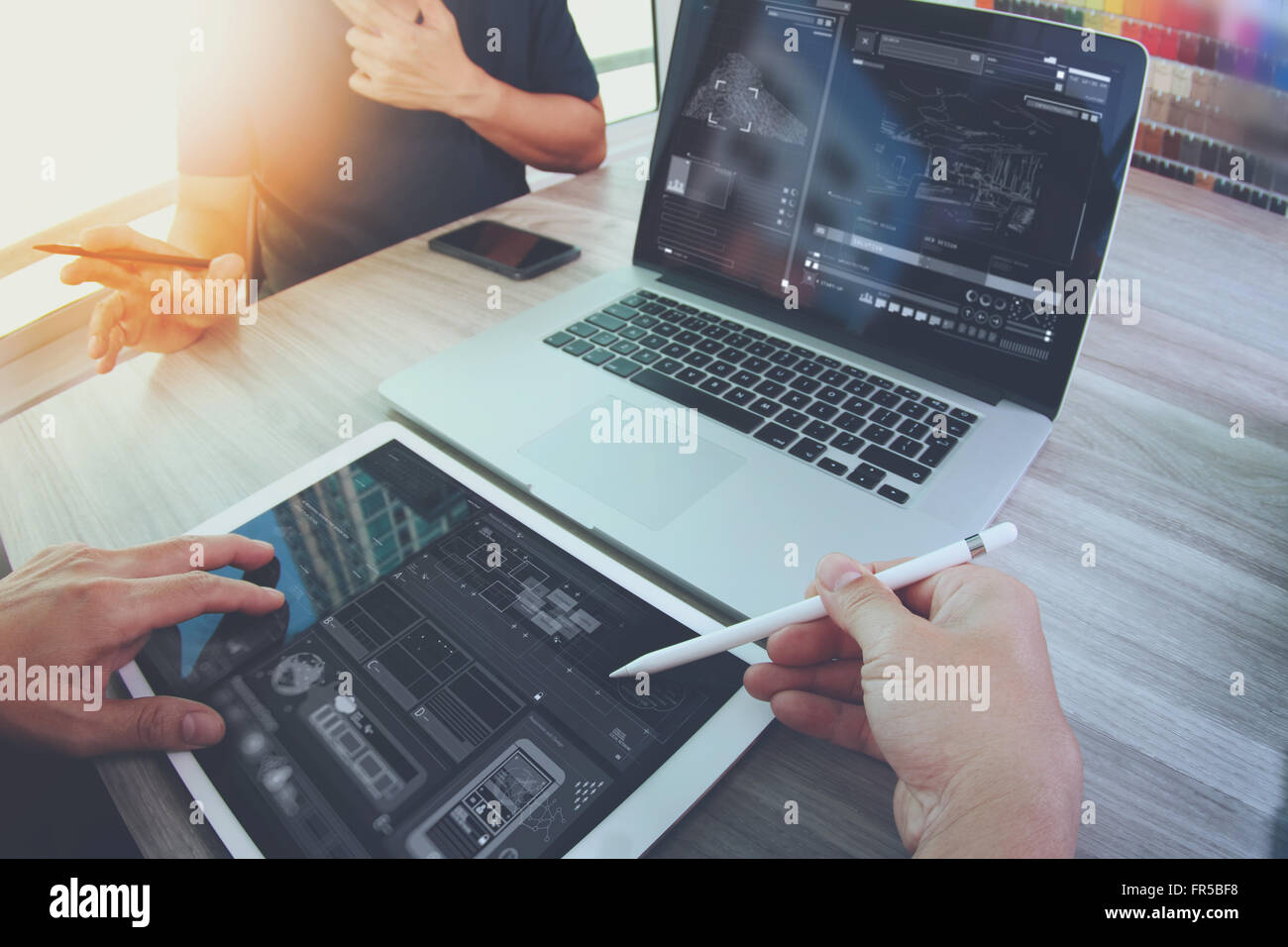 two colleagues Website designer working digital tablet and computer ...