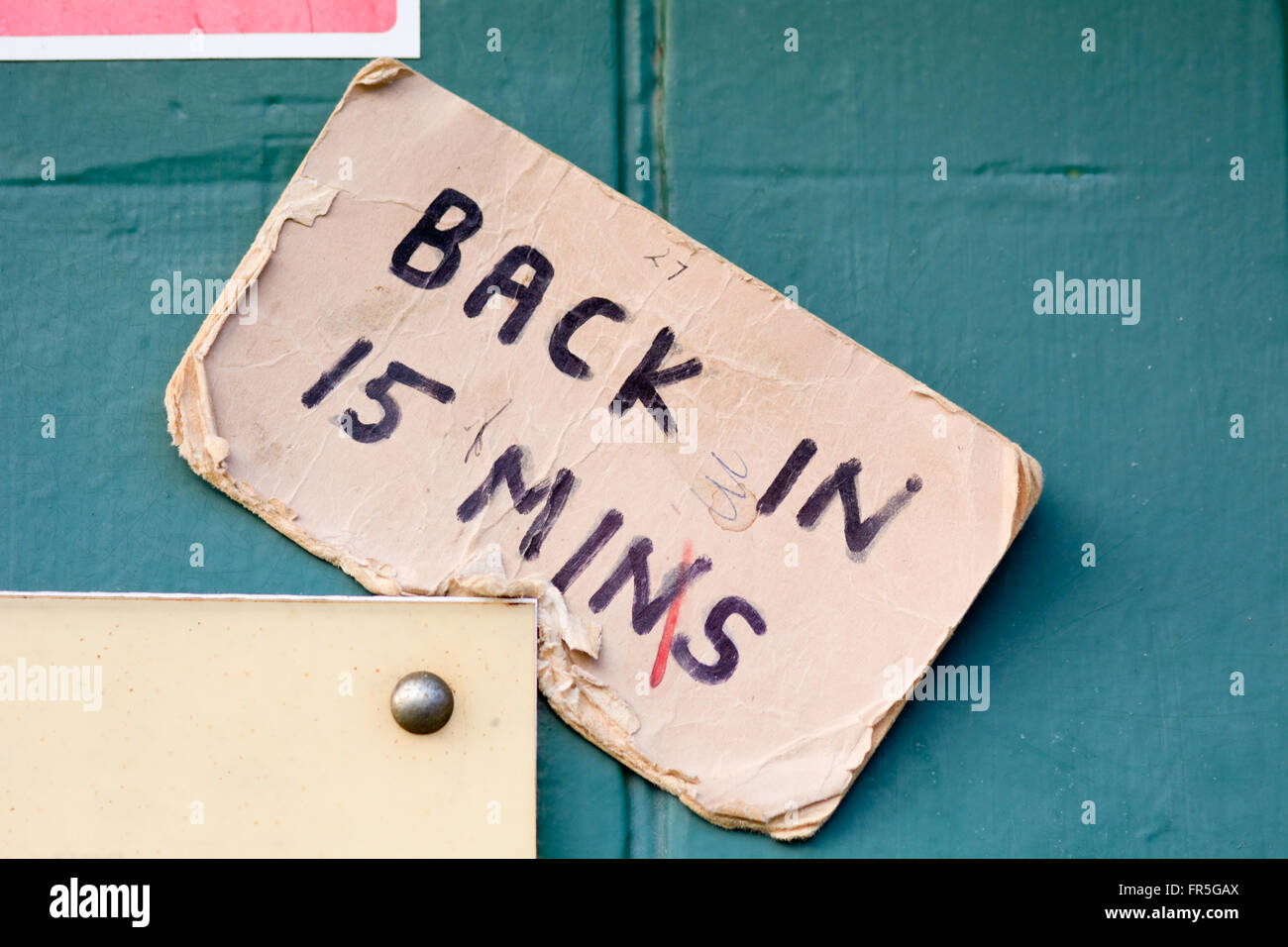 Back in 15 minutes handwritten sign on doorway outside business ...