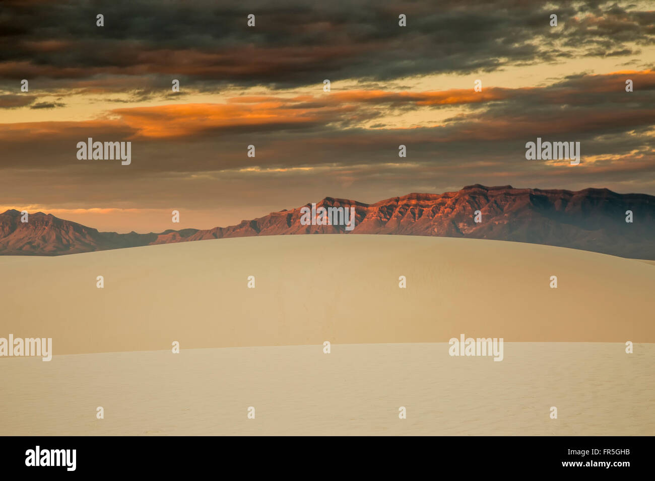 Dramatic sunset sky over sand dunes and mountains, White Sands, New ...