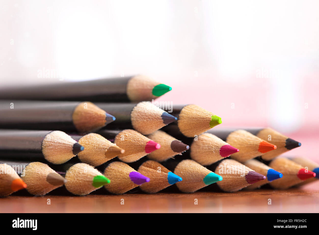 Colored pencils on the table on an abstract background Stock Photo - Alamy