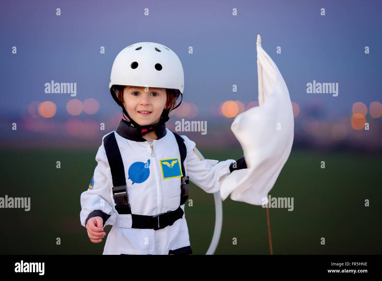 Adorable little boy, dressed as astronaut, playing in the park with ...