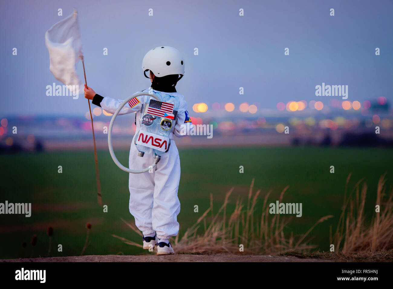 Adorable little boy, dressed as astronaut, playing in the park with ...