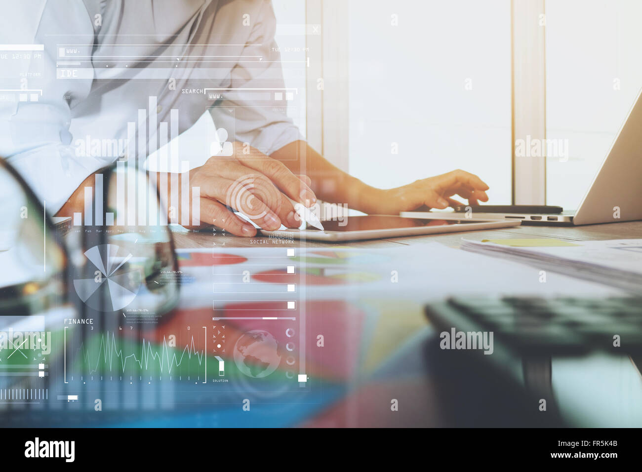 business documents on office table with laptop computer and graph ...