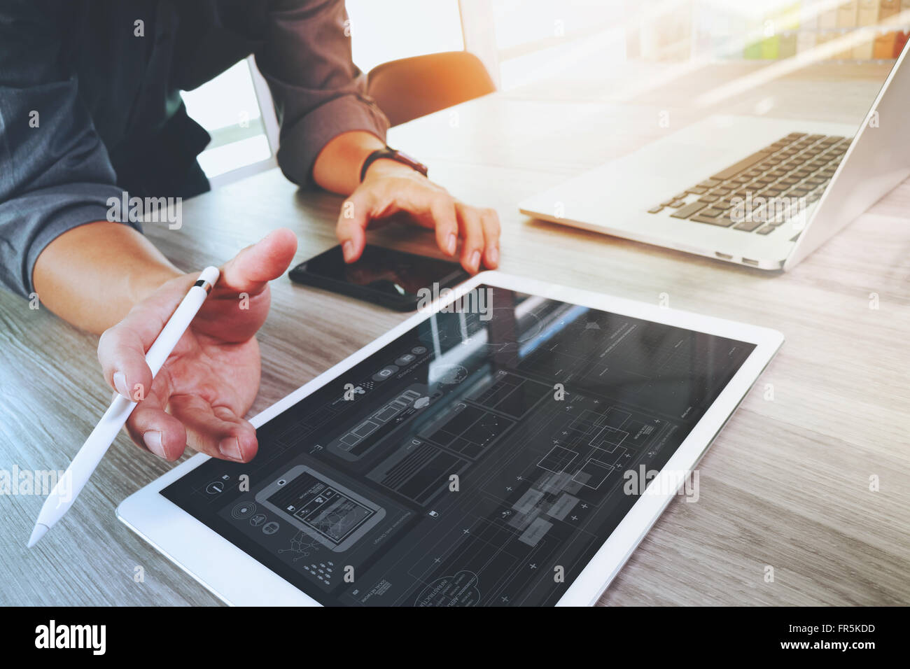 Website designer working digital tablet and computer laptop and digital design diagram on wooden ...