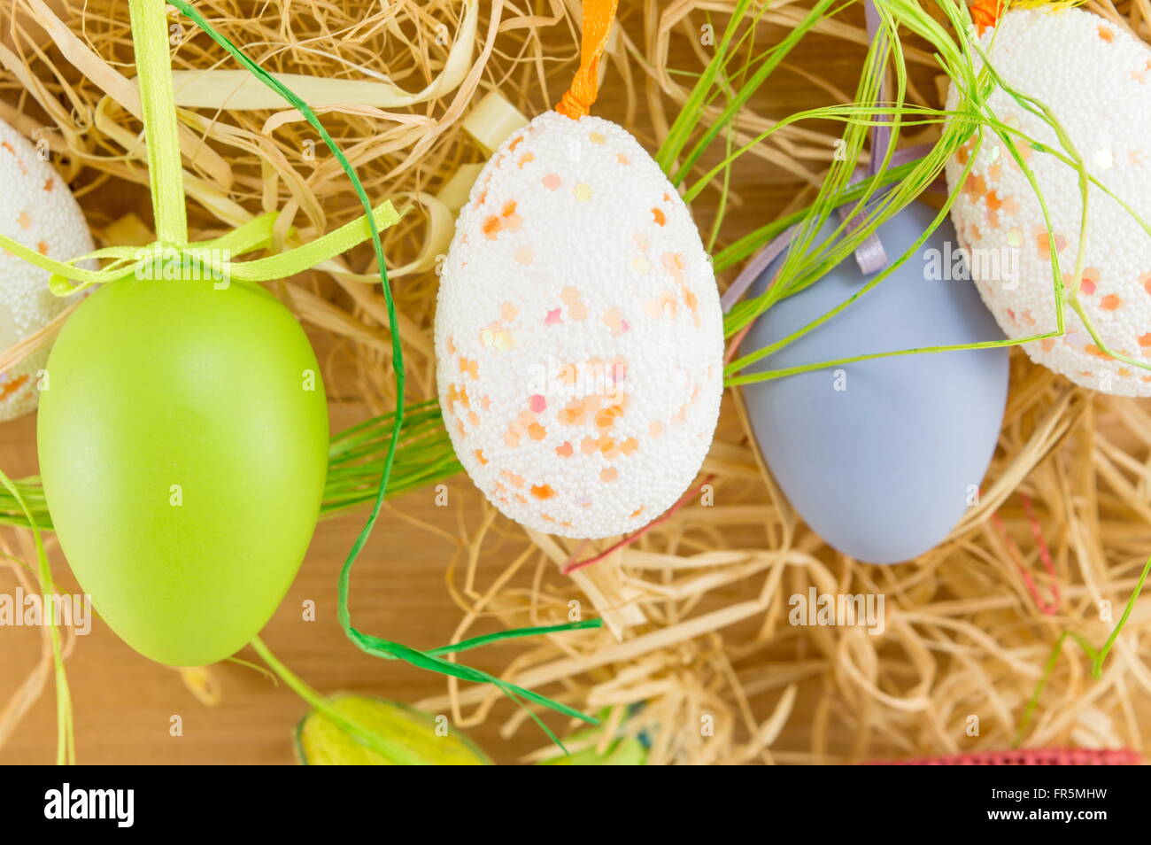 Easter eggs hanging from the colorful ropes Stock Photo - Alamy