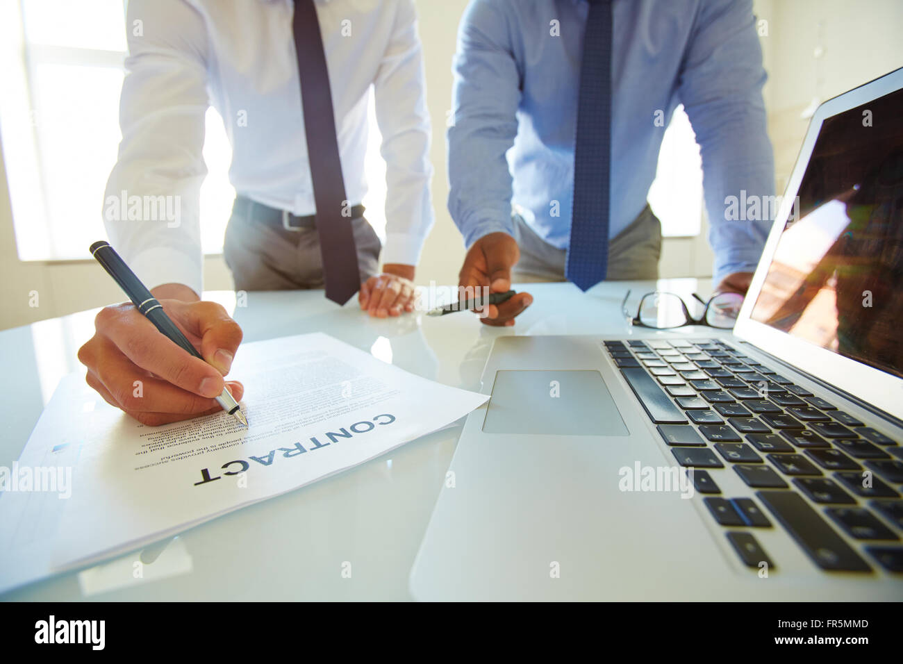 Close up partners signing contract hi-res stock photography and images ...