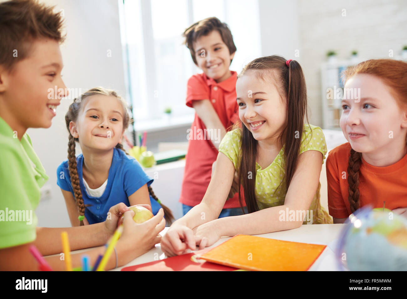 Group of schoolchildren working in team at the lesson Stock Photo - Alamy