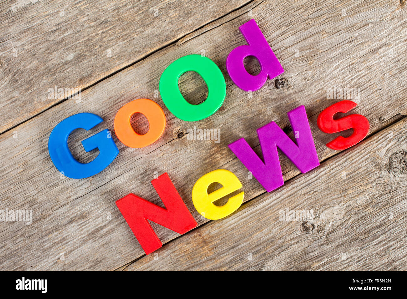 Colored letter magnets spelling text GOOD NEWS Stock Photo - Alamy