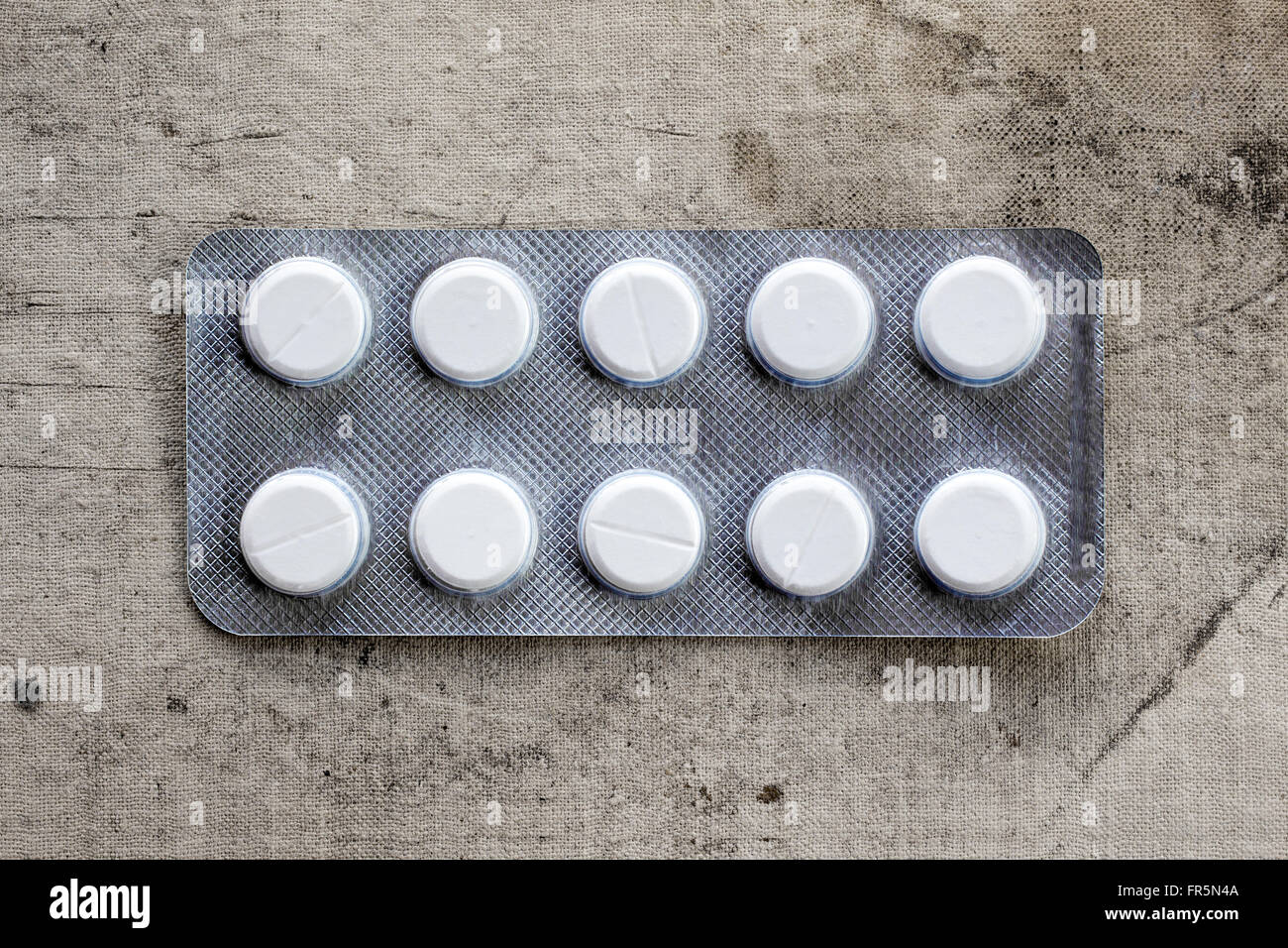 Pills in a blister pack on dirty canvas background Stock Photo - Alamy