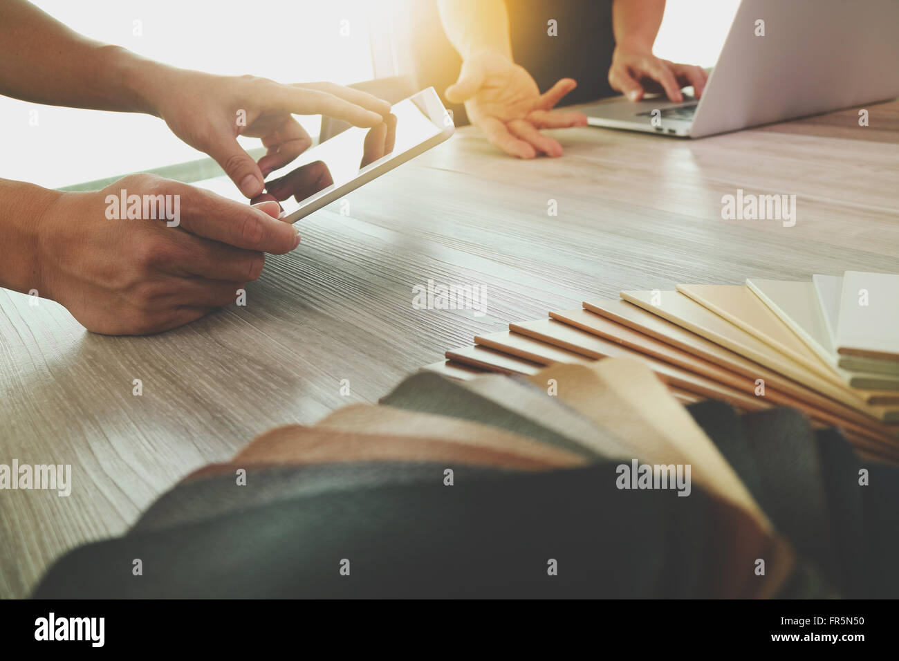 two colleagues interior designers discussing data with blank screen new ...