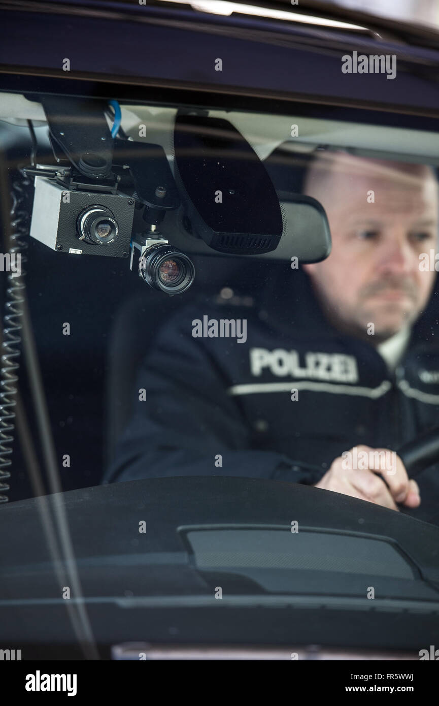 A police officer of the Police Academy Hesse sitting in a police car ...