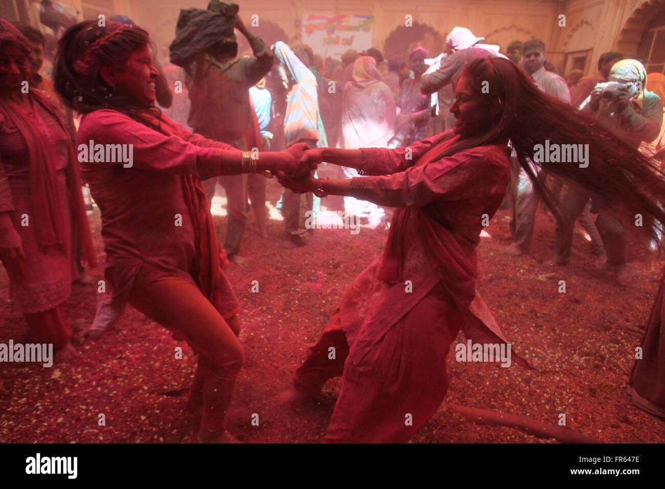 Mathura, India. 21st Mar, 2016. Devotees enjoy dancing and throwing of ...