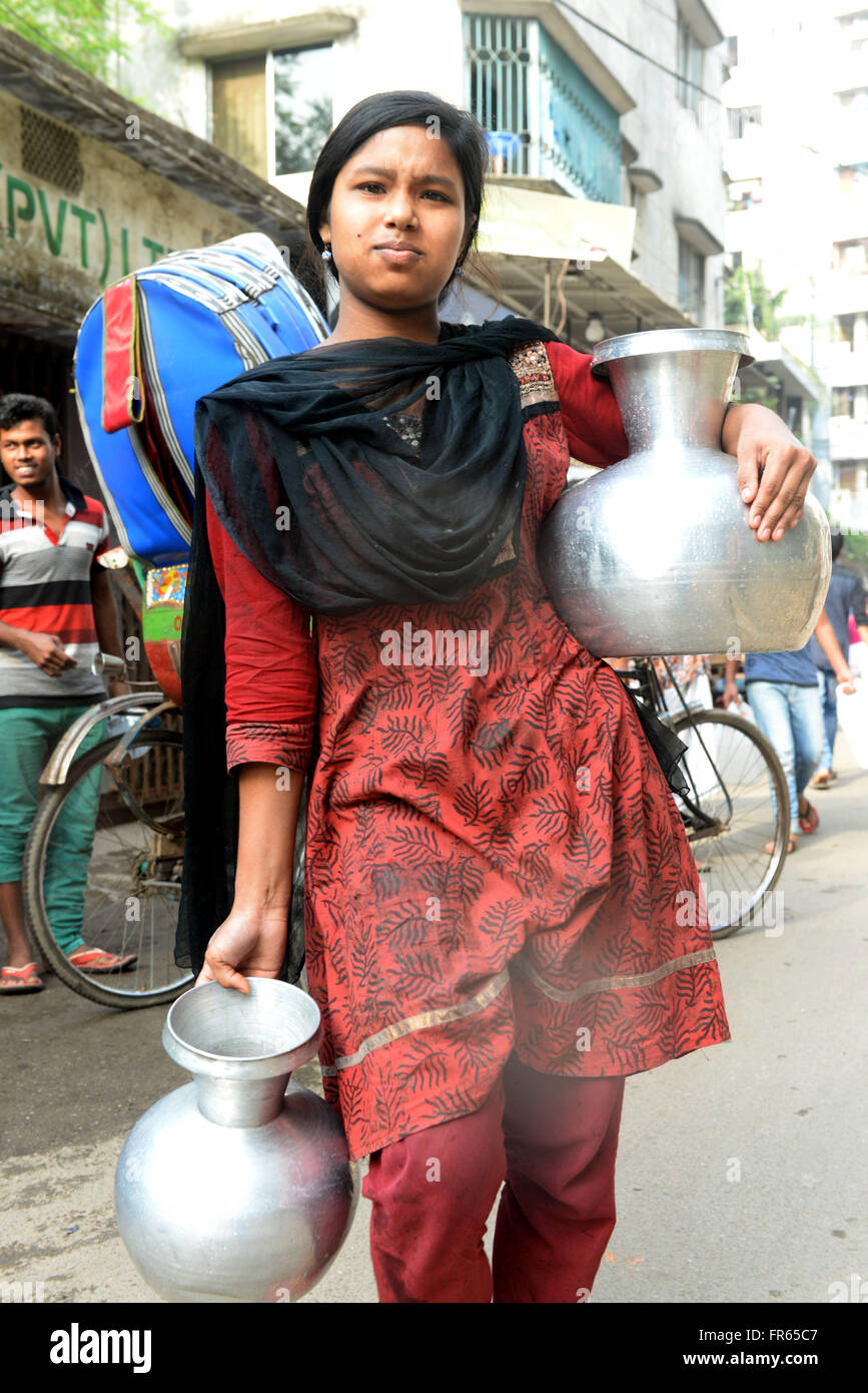 Dhaka, Bangladesh. 22nd Mar, 2016. A woman carries water pots at Wari ...
