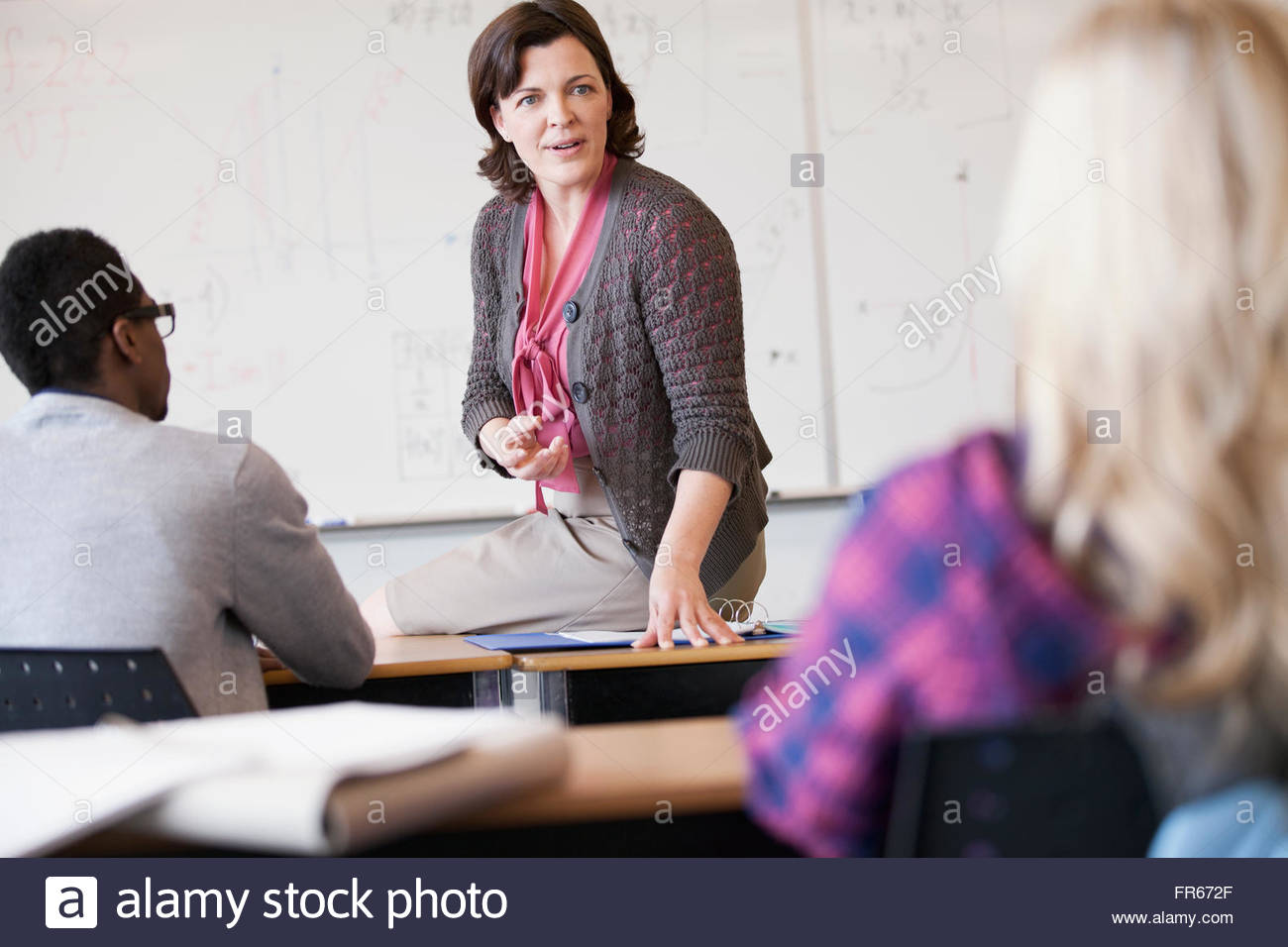 Man teacher leaning on desk hi-res stock photography and images - Alamy