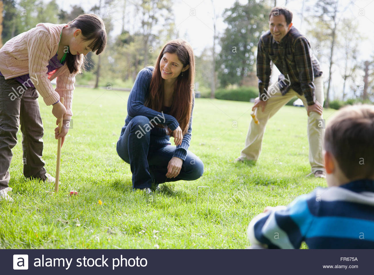 family playing croquet in the park Stock Photo - Alamy