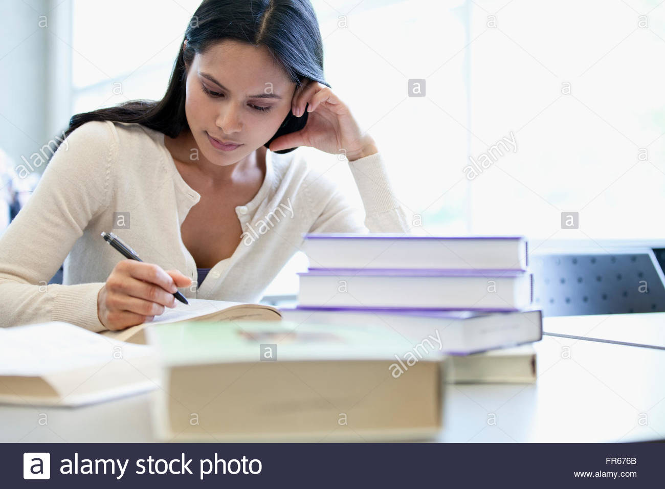 female college student writing paper in classroom Stock Photo - Alamy
