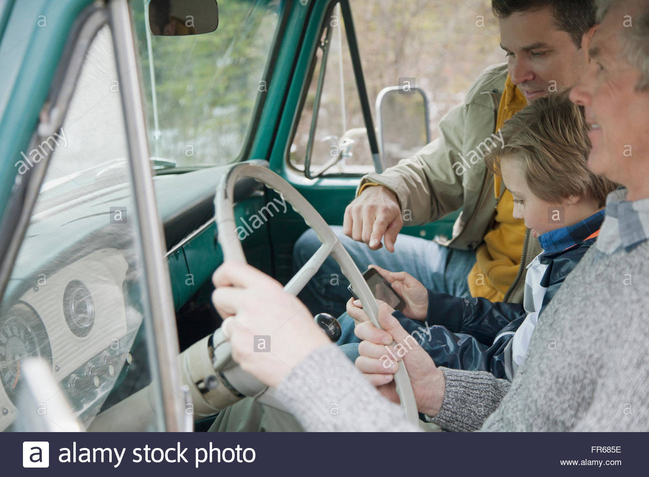 father helping son with navigation on gps Stock Photo - Alamy