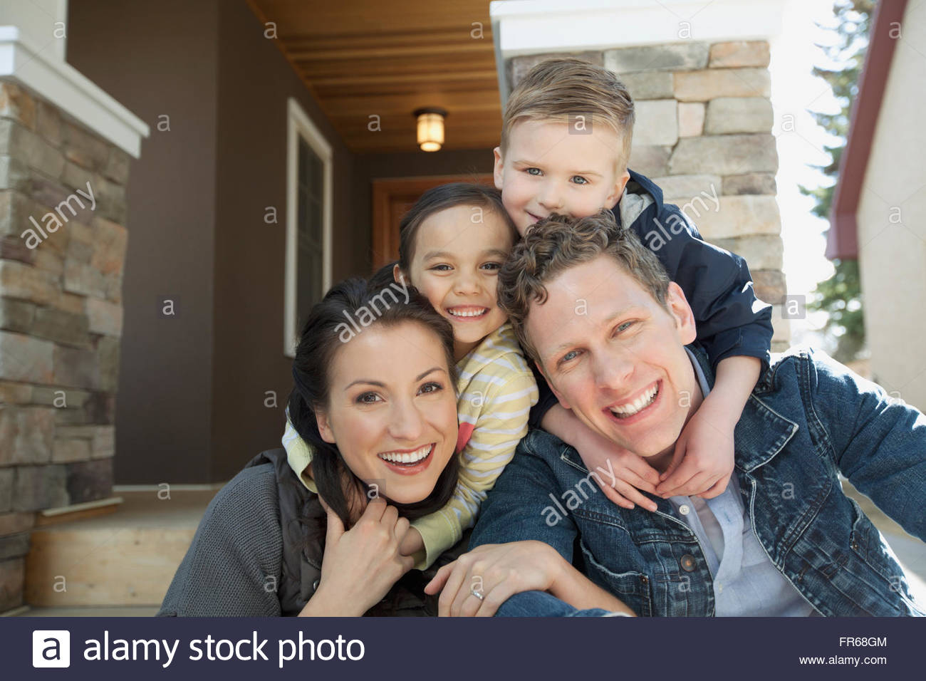portrait of young family outside residence Stock Photo - Alamy