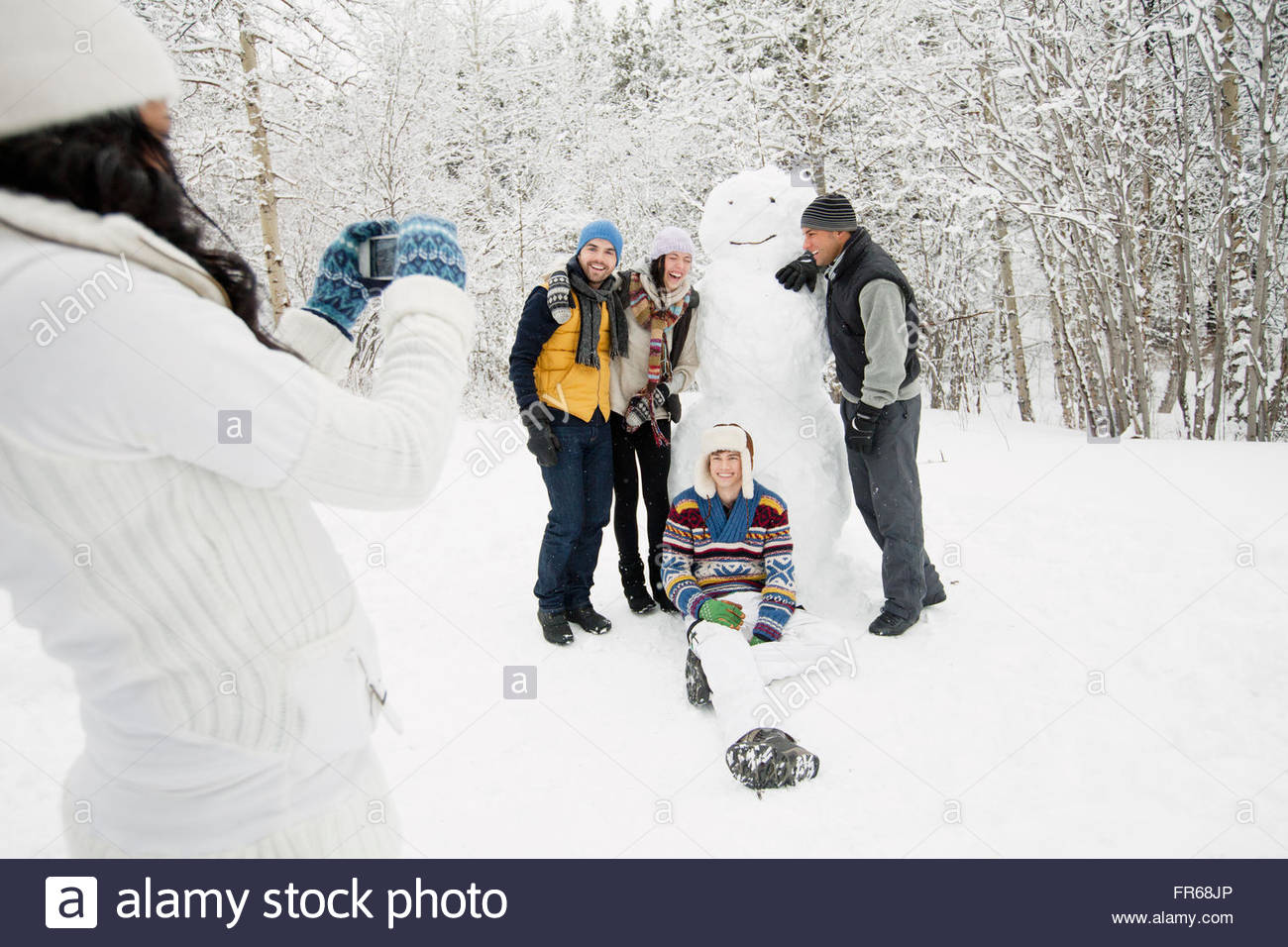 picture taking with snowman Stock Photo - Alamy